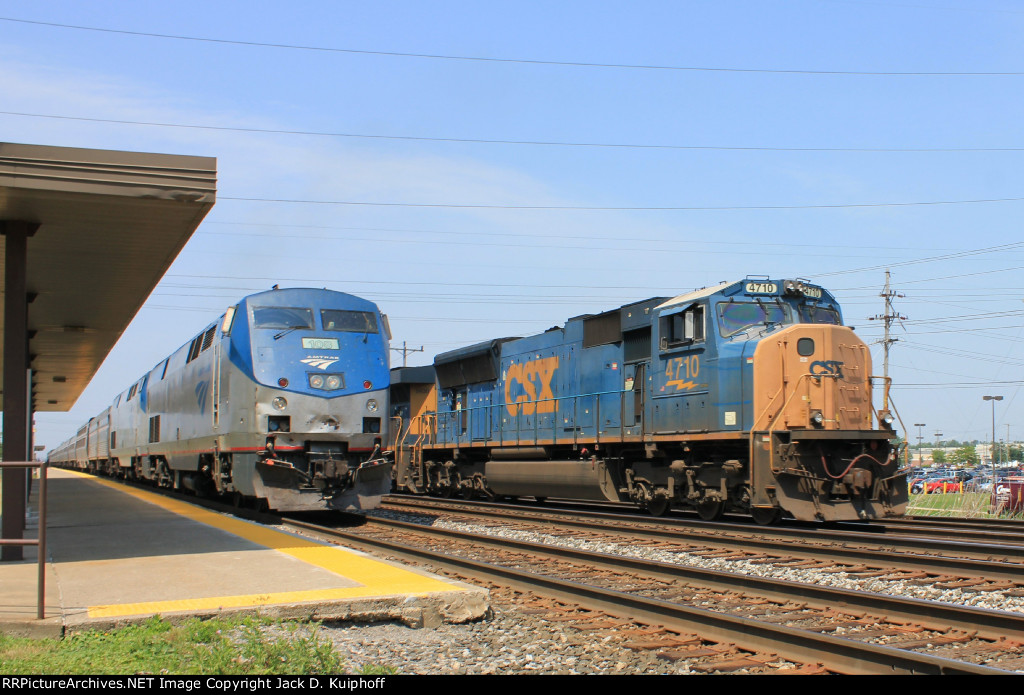 AMTK 108 with a battered nose, and 49 with train #48 is passed by CSX 4710 at the station